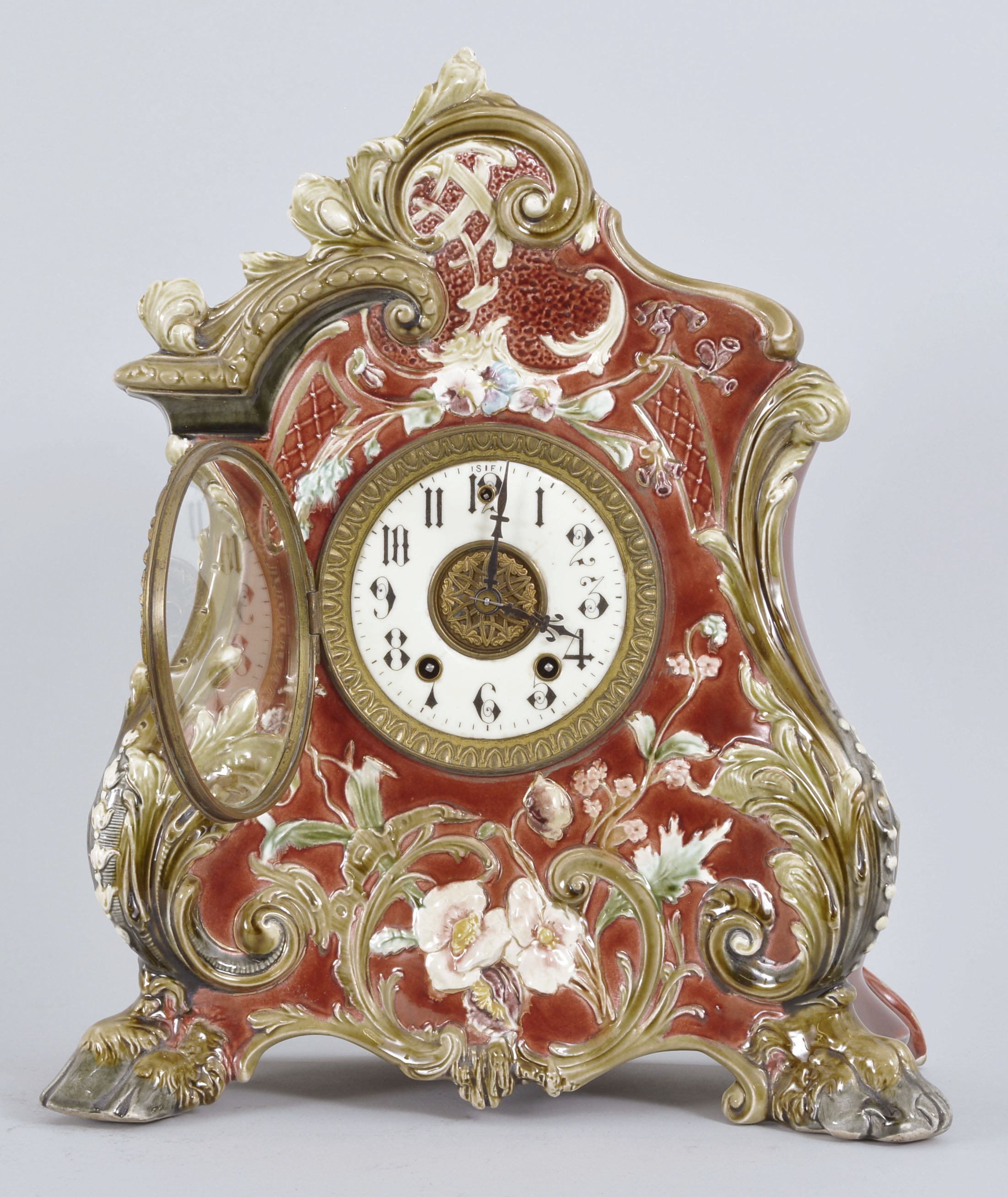 Rare Gilbert mantel clock in a dark red porcelain case